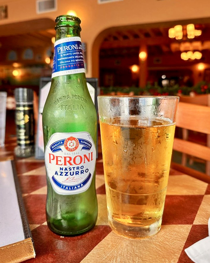 A cold Peroni stands at attention, condensation beading on the bottle like it's as excited about your meal as you are.