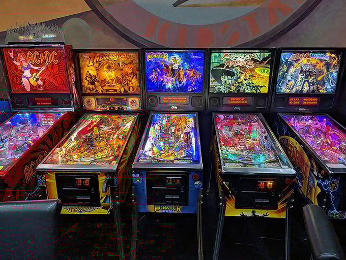 Pinball machines line up like mechanical time capsules, their playfields a symphony of lights, bumpers, and flippers awaiting skilled hands.