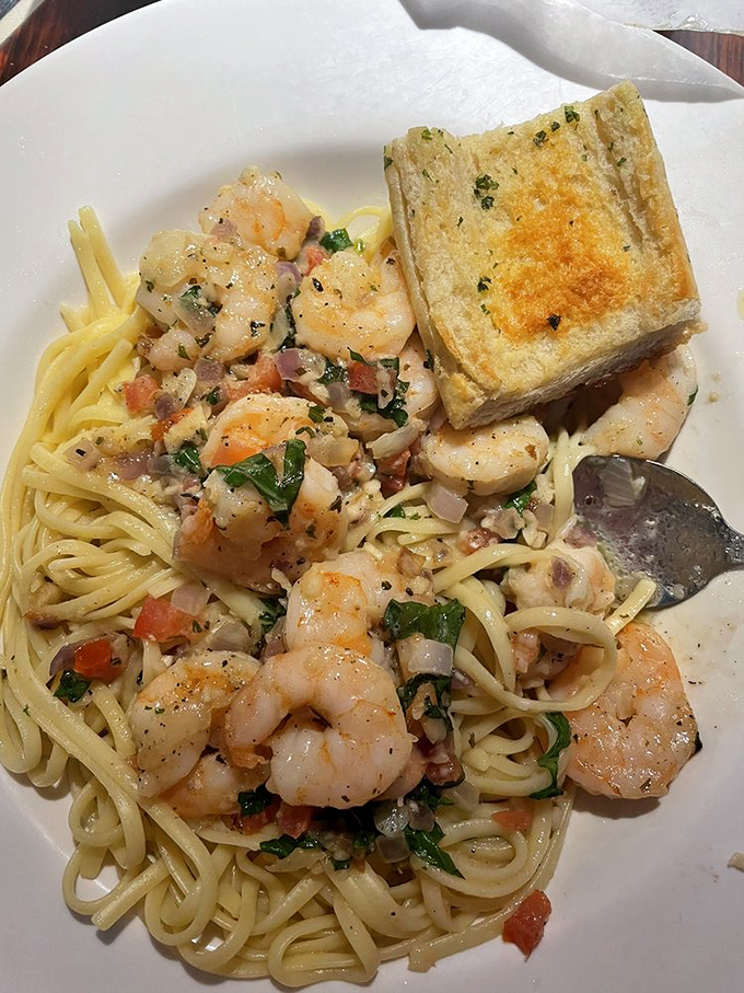 Shrimp scampi where garlic and butter perform their magic dance. That garlic bread isn't just a side &ndash; it's essential sauce-sopping equipment.