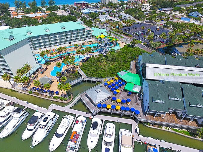 From above, the entire complex reveals itself as a waterfront oasis where slides, pools, and marina views create one spectacular package.