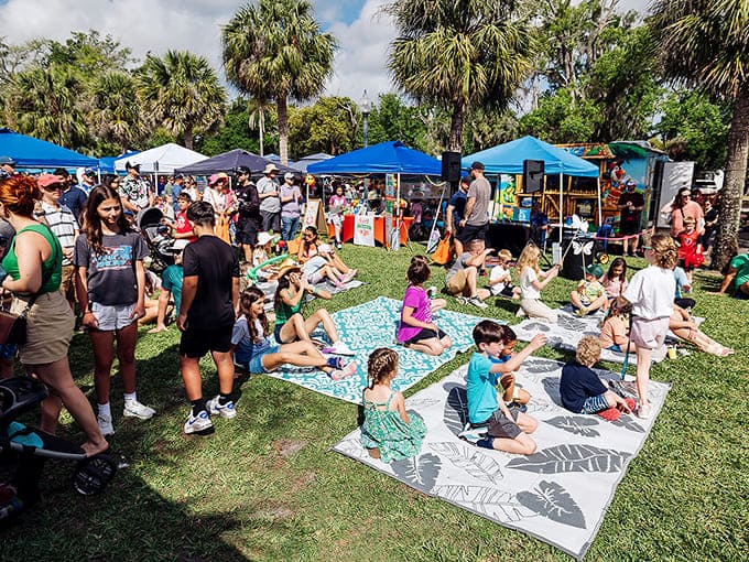 Families spread out on blankets in the grass, turning the festival into an impromptu picnic that's basically a Norman Rockwell painting with better plants.