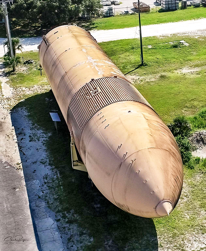 Bird's-eye view of a grounded space giant. From above, the tank resembles a misplaced missile or perhaps the world's largest forgotten cigar.