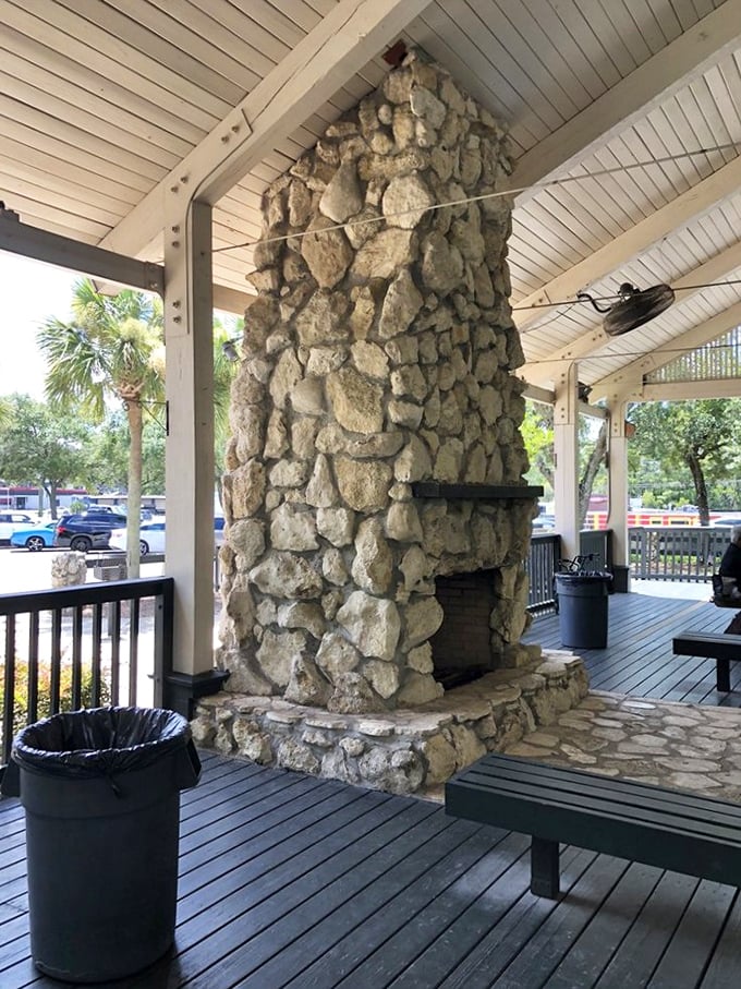 This magnificent stone fireplace anchors the pavilion, its rugged craftsmanship echoing the natural beauty that surrounds it.