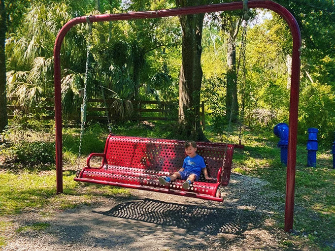 This red swing bench might be the most fought-over spot in the preserve &ndash; worth the wait for a moment of suspended bliss.