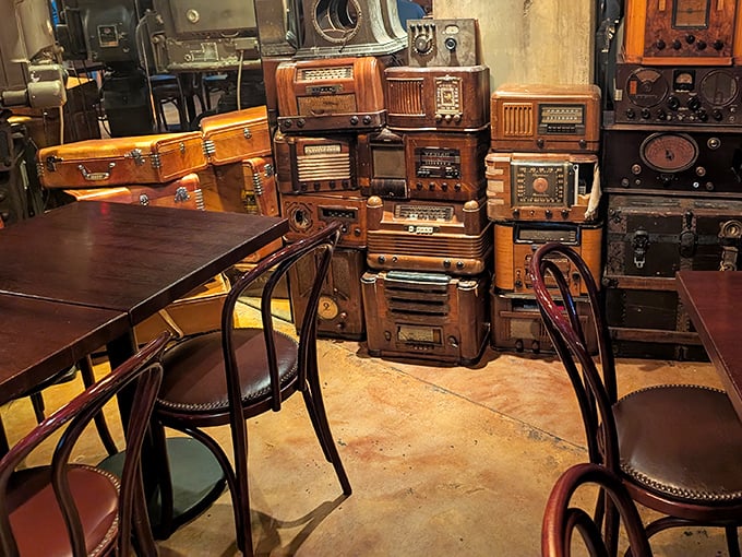Vintage radios stacked like building blocks create a unique architectural element, surrounding diners with echoes of communication history.
