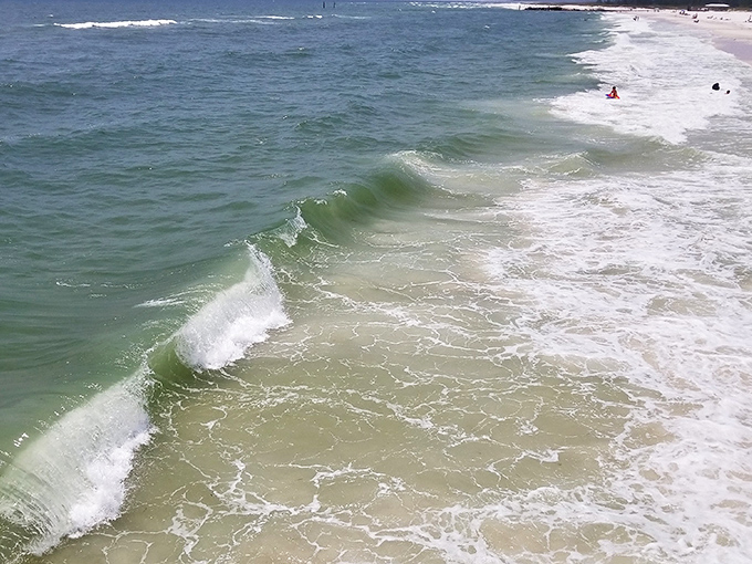 Emerald waves dance their way to shore in hypnotic rhythm &ndash; nature's most reliable entertainment, playing on repeat since time began.