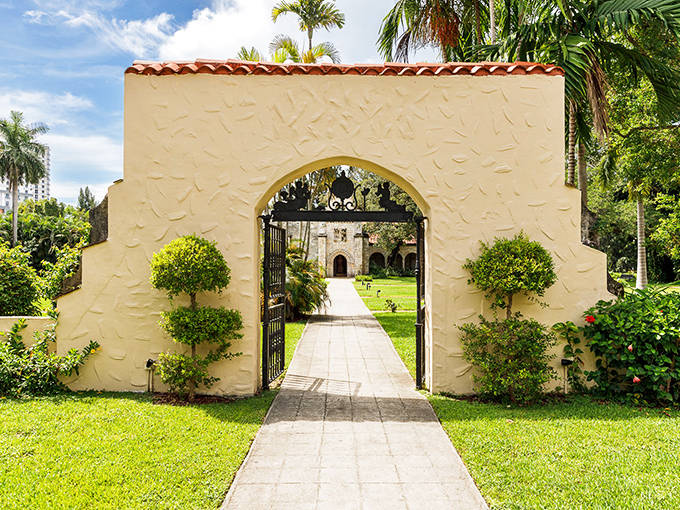 A sun-drenched archway welcomes visitors to the Ancient Spanish Monastery, where medieval European history meets Florida sunshine.