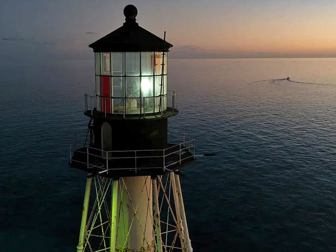 As day turns to night, the lighthouse begins its real job, sending out beams that have guided sailors safely home for over 150 years.
