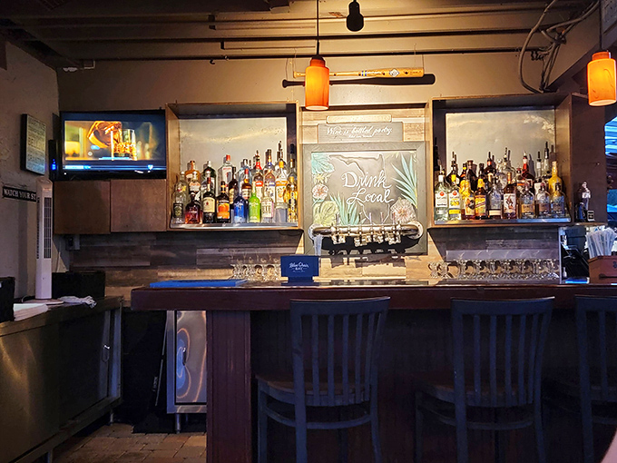 A well-stocked bar with warm wood tones invites you to settle in for a while and let the bartenders work their magic.