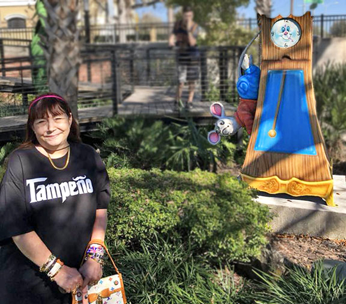 Visitors connect with childhood memories beside the whimsical clock tower, where storybook magic meets Tampa sunshine.