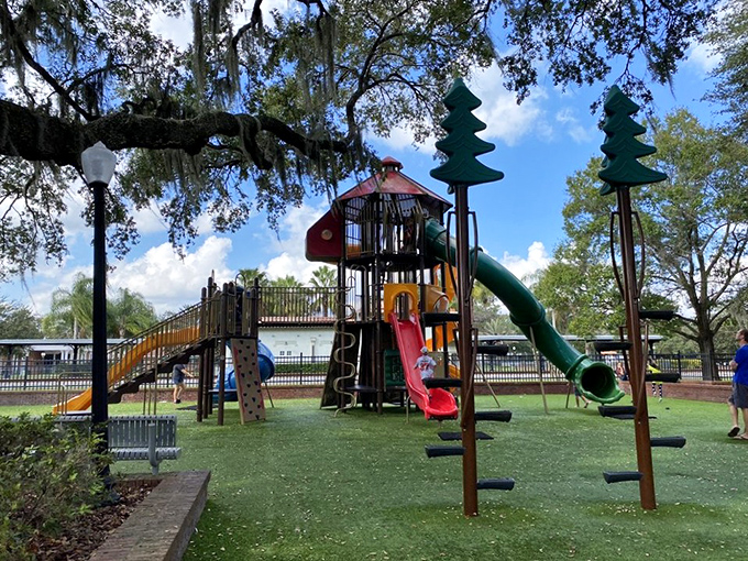 Adventure awaits on this elaborate play structure, where slides and climbing challenges build confidence in young explorers while parents watch from nearby benches.
