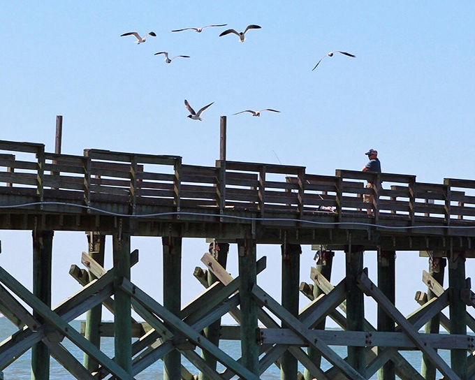 The Mexico Beach Pier attracts both fishermen and photographers, with the former seeking the catch of the day and the latter capturing day's end.