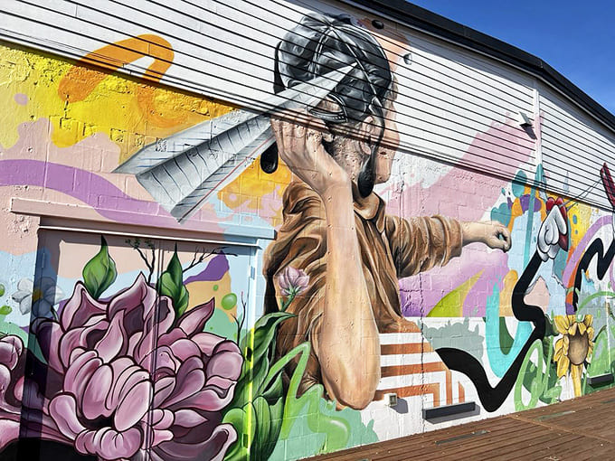 Vibrant street art outside celebrates maternal strength with colors as bold as the women it honors.