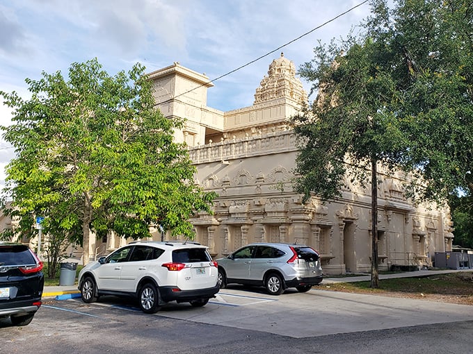 Even the parking area maintains a sense of reverence, with the temple's impressive structure looming over everyday vehicles like a spiritual supervisor.