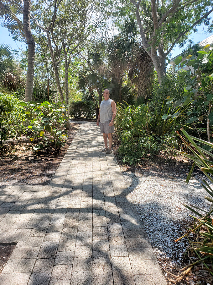 Shaded walkways meander through tropical foliage, creating natural corridors between buildings where history whispers with every step.