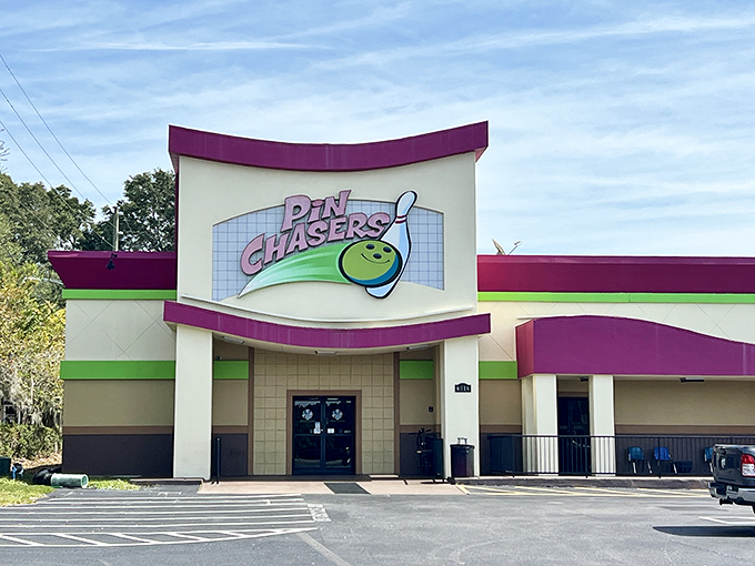 Pin Chasers' retro neon sign promises good times inside this bowling alley where serious league players share lanes with families seeking rainy day fun.