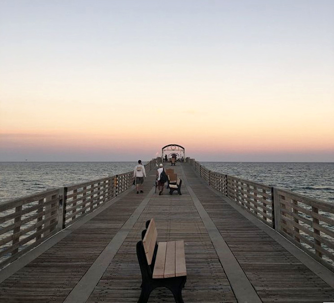 Sunset transforms the pier into a romantic destination, where couples gather to witness nature's most reliable light show.