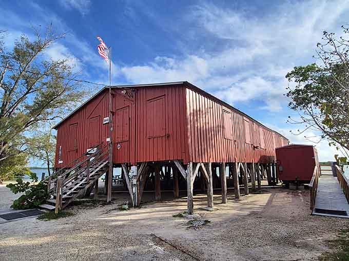 The exterior's weathered red paint and stilted construction scream "hurricane-proof" louder than any modern building code ever could manage.
