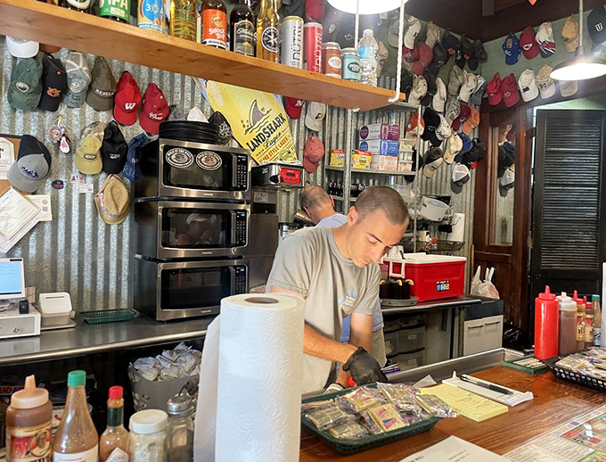 Behind the scenes, skilled hands prepare seafood with the precision that comes only from years of practice.