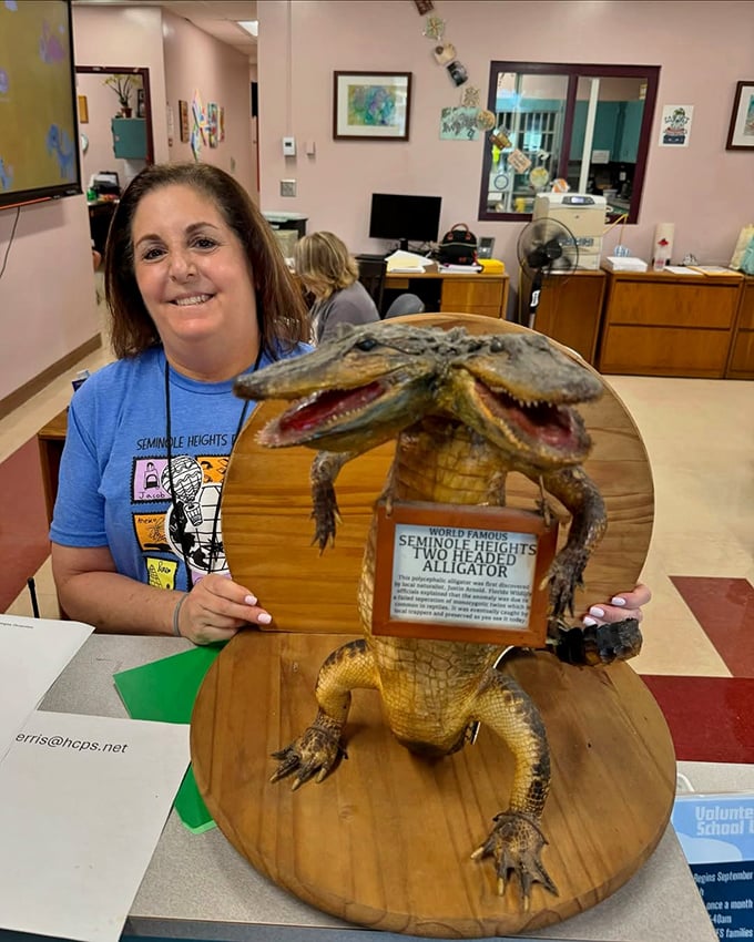 School pride meets cryptozoology &ndash; this staff member proudly displays the neighborhood's famous taxidermy specimen.