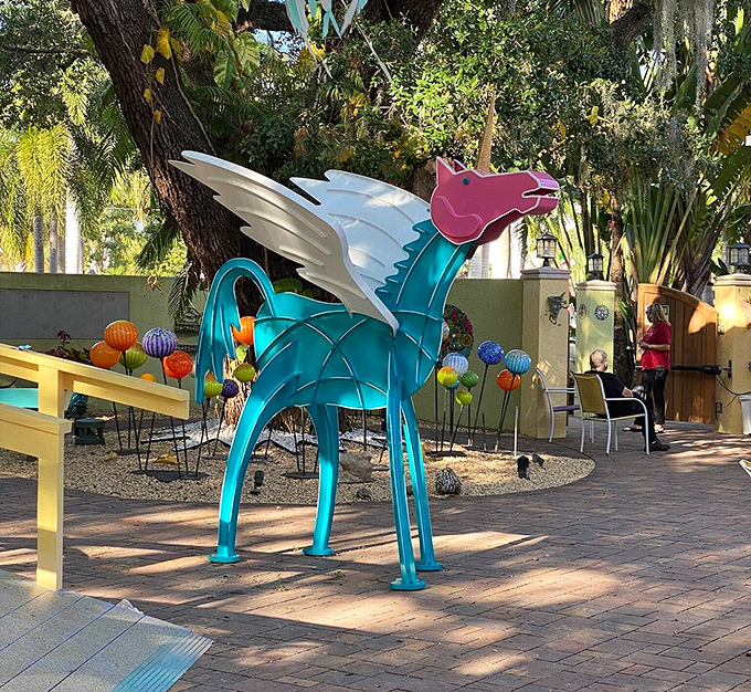 The teal winged horse sculpture combines mythological majesty with Caribbean colors, creating a creature that seems ready to gallop straight into your dreams.