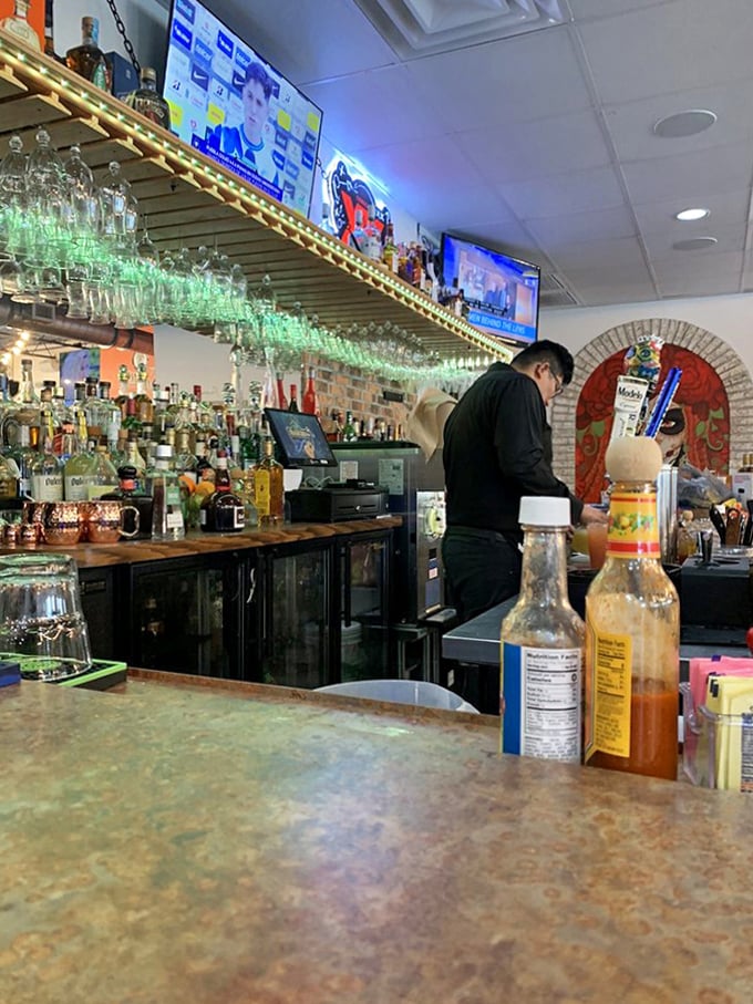 Behind the bar, bottles stand at attention like ambassadors from distant shores, ready to complement your cross-cultural feast.