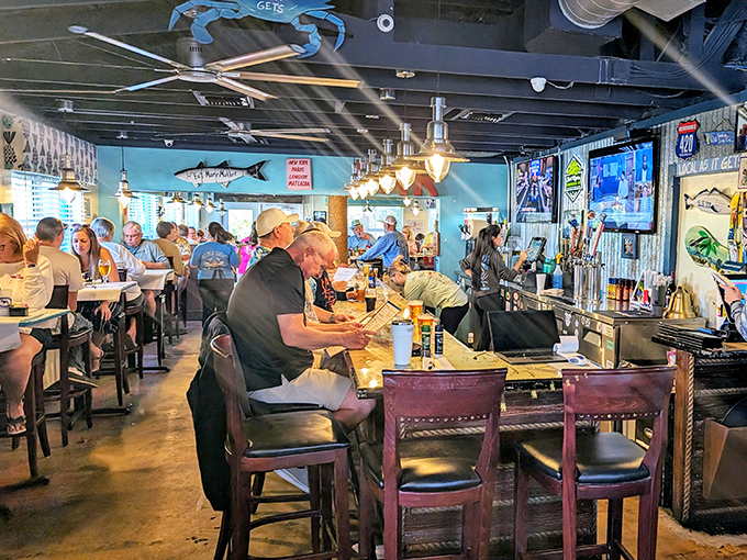Happy patrons fill the bar area, creating the convivial atmosphere that makes Blue Dog as much about community as cuisine.