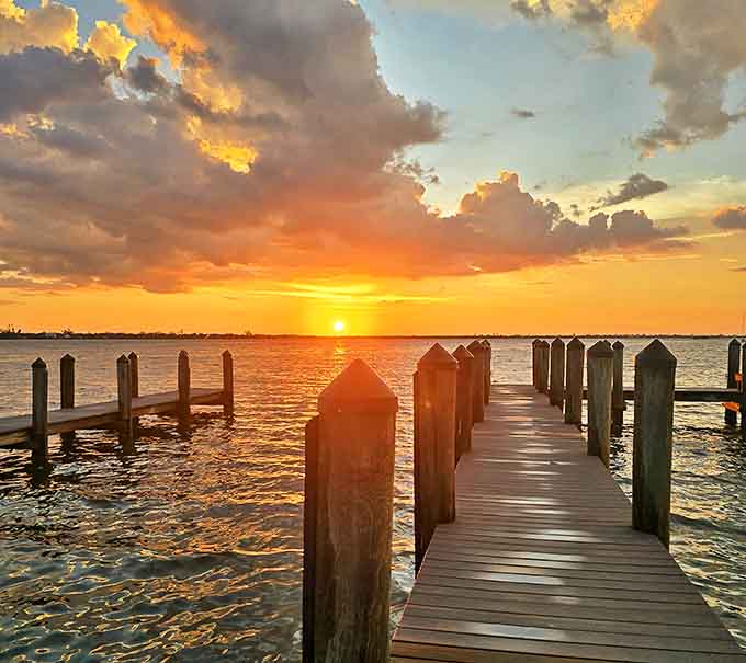 Sunset at Bryant Park transforms the Intracoastal Waterway into a canvas of golden light and silhouetted palm trees.