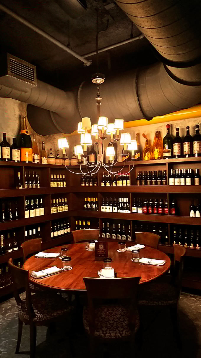 The wine room offers intimate dining surrounded by carefully selected bottles, all beneath the gentle glow of a chandelier and exposed pipes.