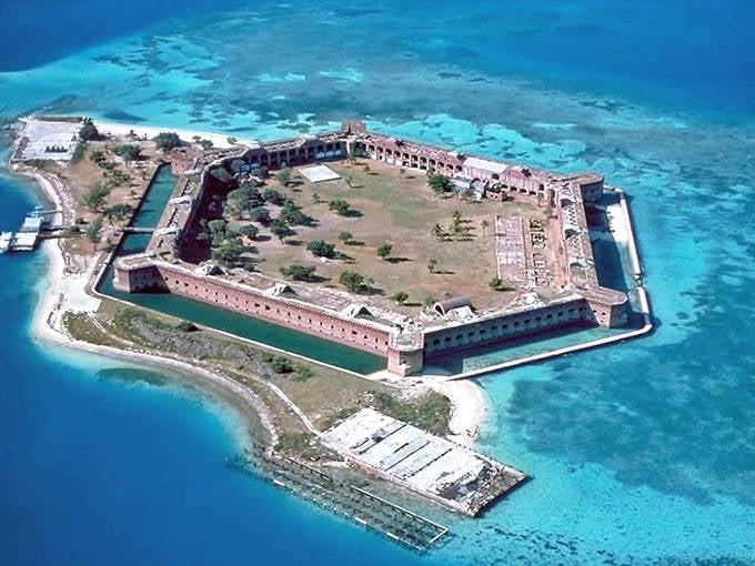 Fort Jefferson's massive hexagonal structure rises from turquoise waters, a brick fortress surrounded by natural beauty.