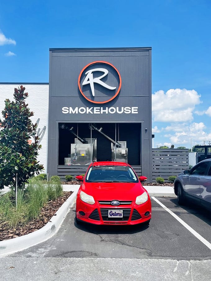 4 Rivers Smokehouse's modern black exterior with its distinctive logo signals serious barbecue business is happening inside.