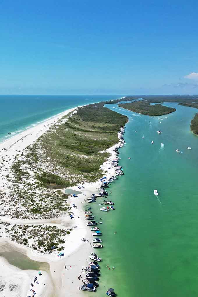 Boats gather along Keewaydin Island's pristine shoreline, creating a friendly floating community of beach lovers.