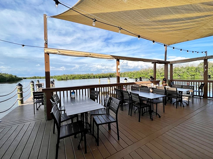 Al fresco dining at its finest, where gentle breezes, water views, and string lights create the perfect dinner backdrop.
