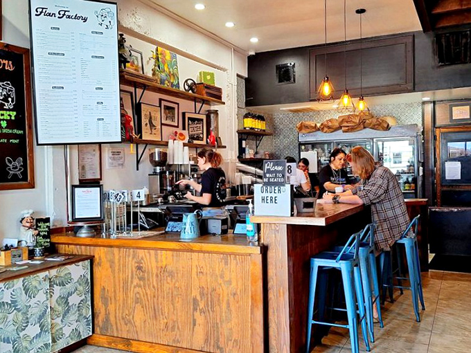 Where coffee magic happens&mdash;the wooden counter and blue stools invite you to linger over cortaditos while plotting which flan to try next.