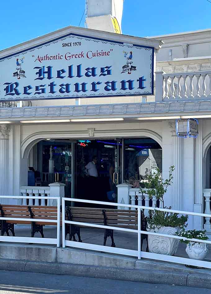The entrance welcomes you with classic Greek styling that promises authentic flavors and genuine hospitality await inside.