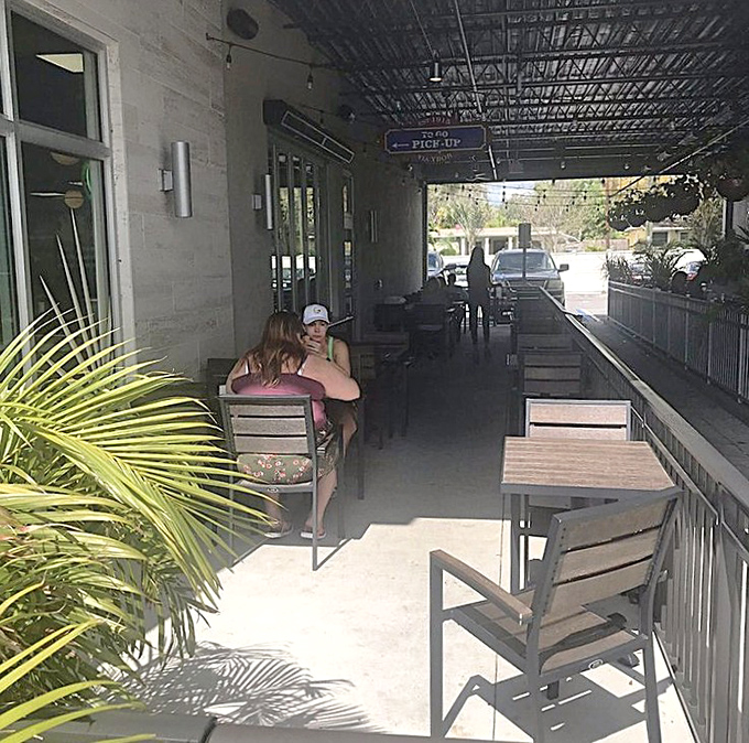 Palm-fringed outdoor seating where the Florida sunshine enhances every bite, making al fresco dining feel like a mini vacation.