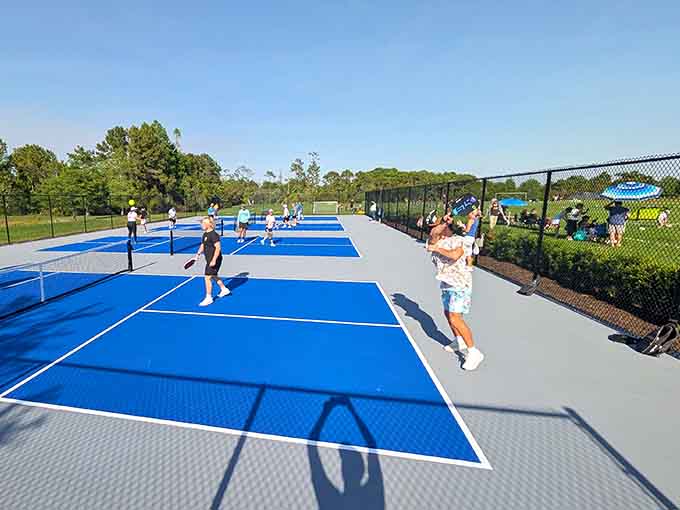 Tennis courts with pristine blue surfaces invite friendly competition, where the only thing getting served is good times and maybe some aces.