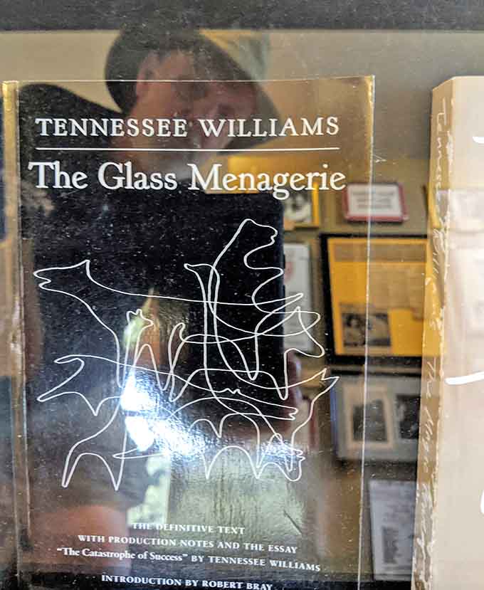 A copy of "The Glass Menagerie" sits among the exhibits, representing Williams' most autobiographical work and his ability to transform personal pain into universal art.