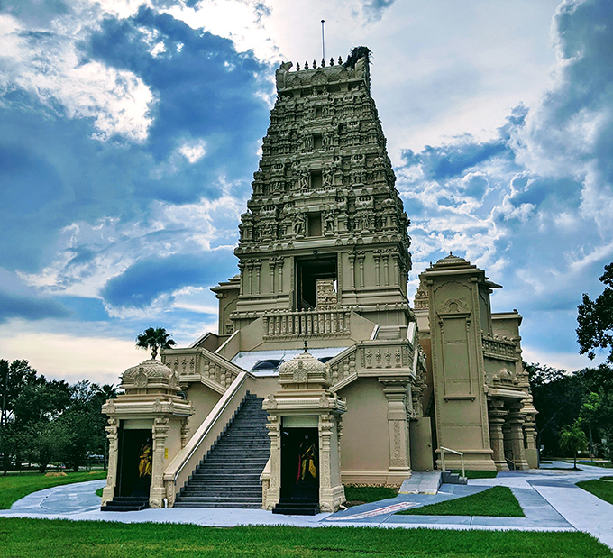 The temple's main tower reaches skyward, its intricate carvings catching the light in ways that make photographers weep with joy.
