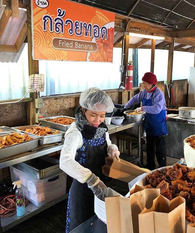 Volunteers prepare fried bananas and other Thai treats with the efficiency of people who've perfected their craft over years.