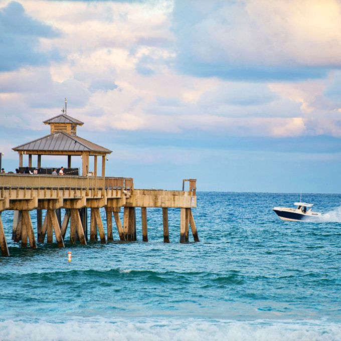 The pavilion watches over passing boats like a proud lighthouse keeper, standing guard at the edge of the continent.