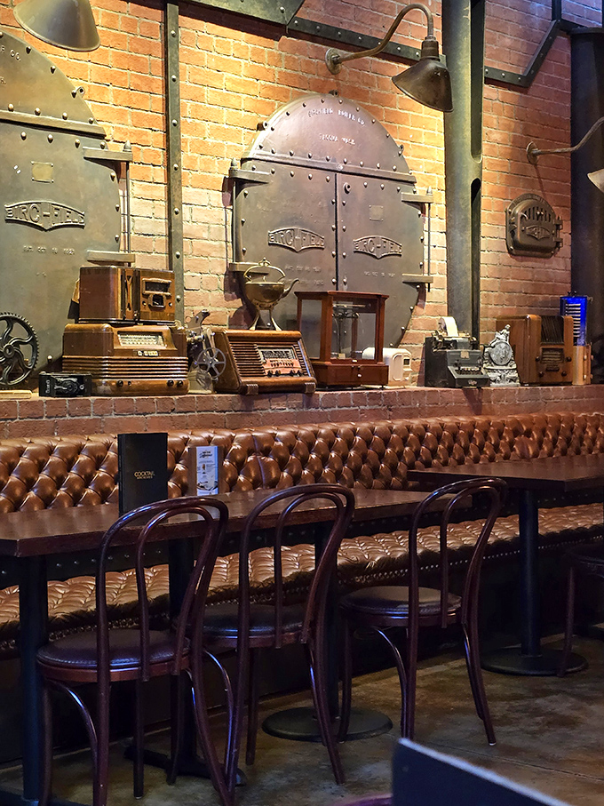 Industrial boilers and mechanical artifacts create an authentic backdrop for dining, making every meal feel like a scene from a steampunk fantasy.
