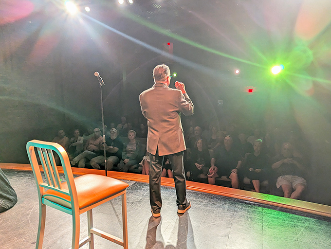 A performer commands the stage with the confidence of someone who knows they're exactly where they belong, in the spotlight.