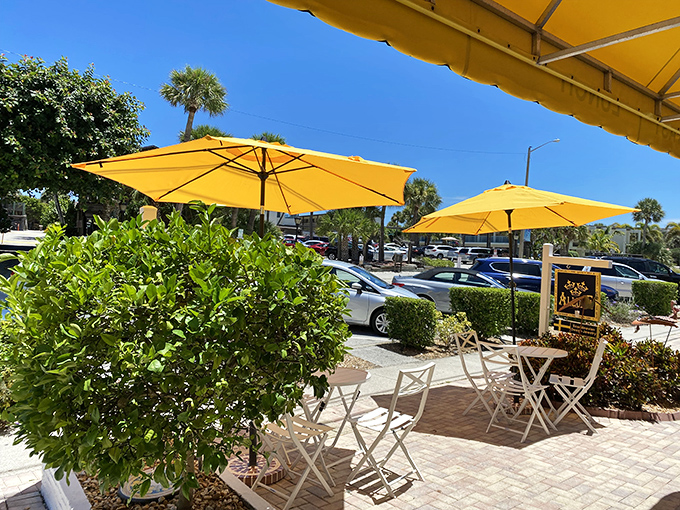Outdoor seating that captures the essence of Florida living&mdash;yellow umbrellas providing shade while you debate whether to order breakfast or lunch.