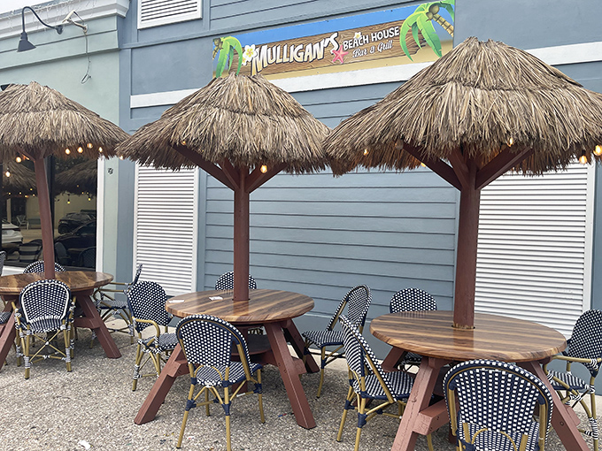 Thatched umbrellas create personal shade islands for outdoor diners, perfect for pretending you're on an exotic vacation during lunch break.