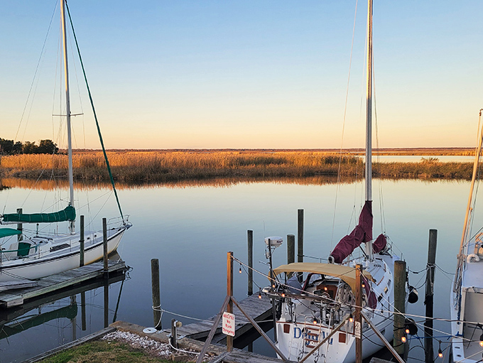 Sailboats rest in perfect stillness as the sun sets&mdash;nature's way of saying even the busiest fishing day deserves a peaceful ending.