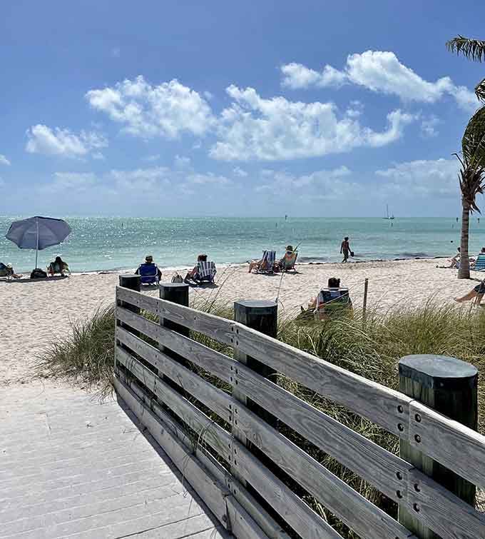 A wooden boardwalk leads you toward the palm-lined shores of the Keys, where clear waters and relaxation are always found.