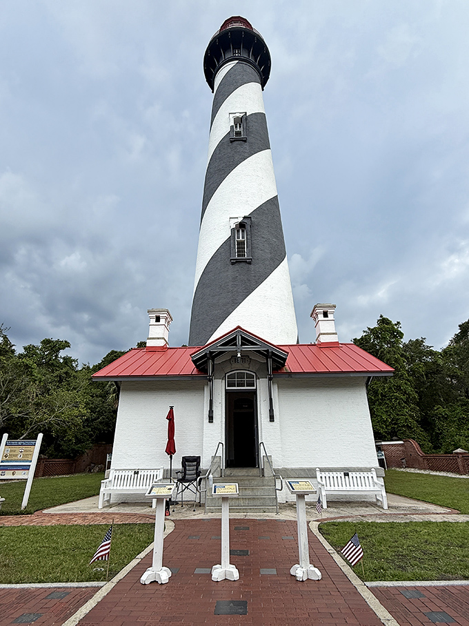 The dramatic spiral pattern of St. Augustine Lighthouse creates a hypnotic effect against the blue sky, a design that's both beautiful and functional for sailors.