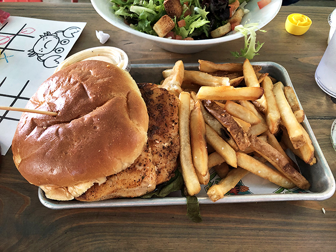 Golden-brown perfection nestled in a soft bun, proving that Krazyfish knows its way around land-based delights too.