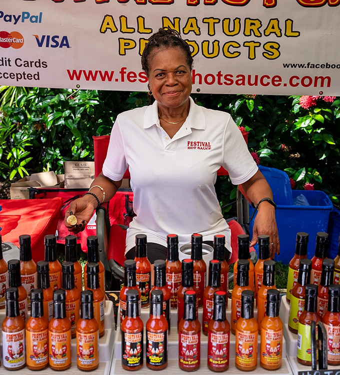 Festival Hot Sauce offers liquid fire in bottles, with the vendor's warm smile providing the perfect counterbalance to her spicy creations.